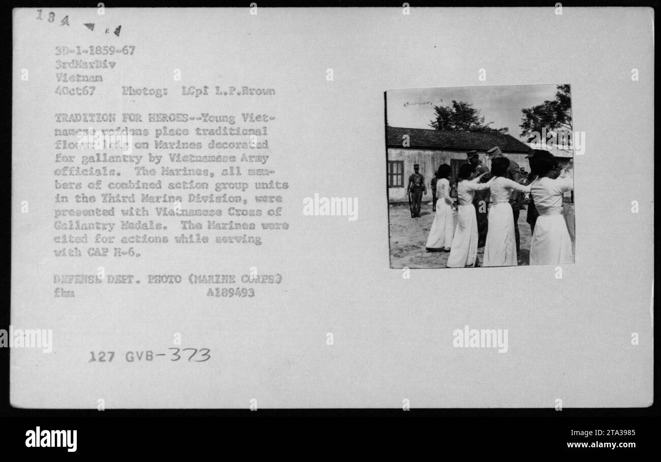 Vietnamese maidens place traditional flower leis on Marines decorated ...