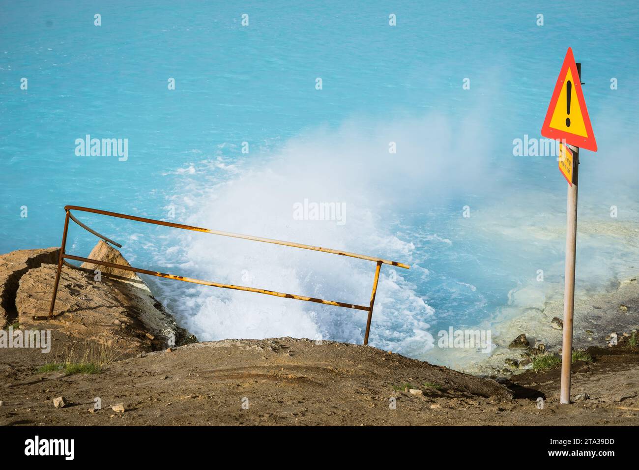 A sign on a beach warning of an incoming wave, alerting beachgoers of ...