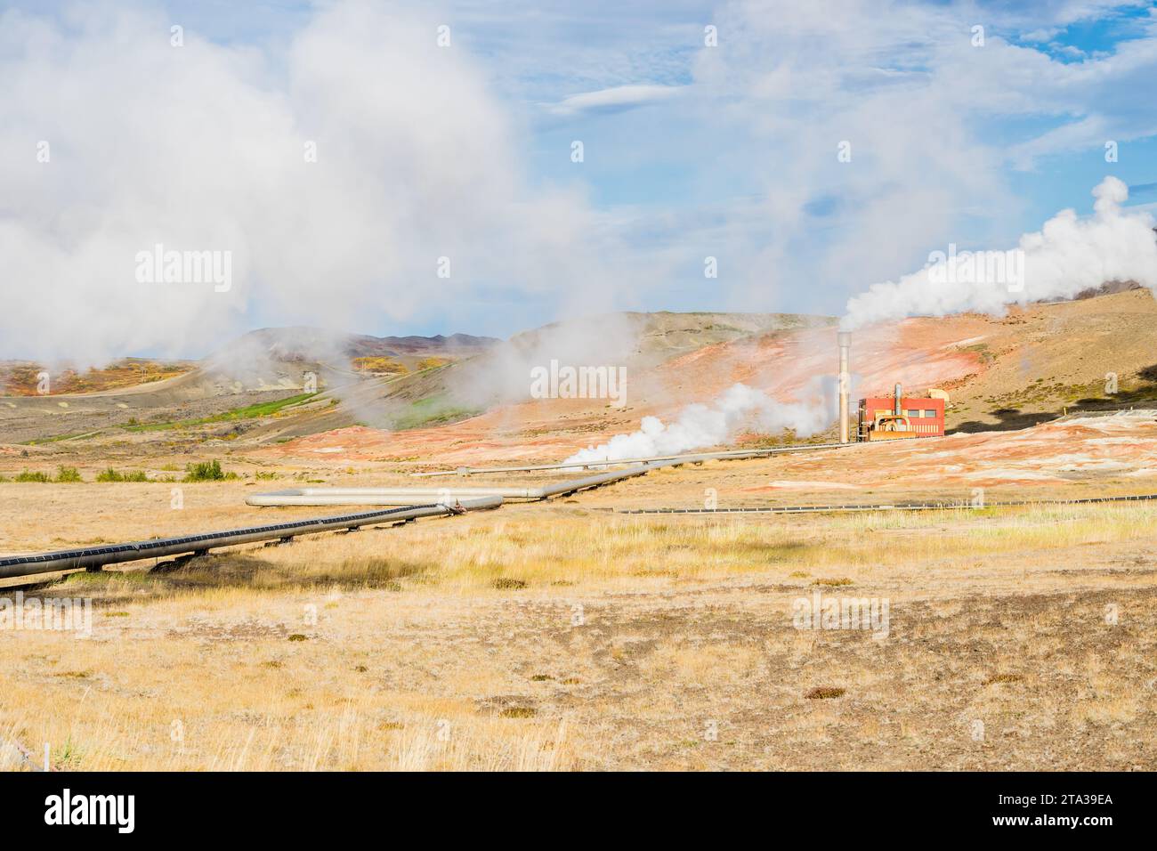 A small steam pipe releasing a plume of vapor into the atmosphere in a ...