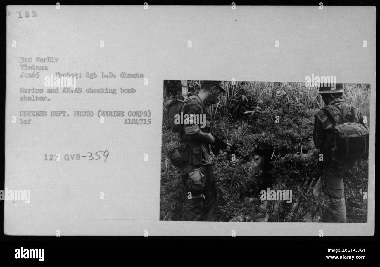 A Marine and an ARVN soldier inspect a bomb shelter in Vietnam in June ...