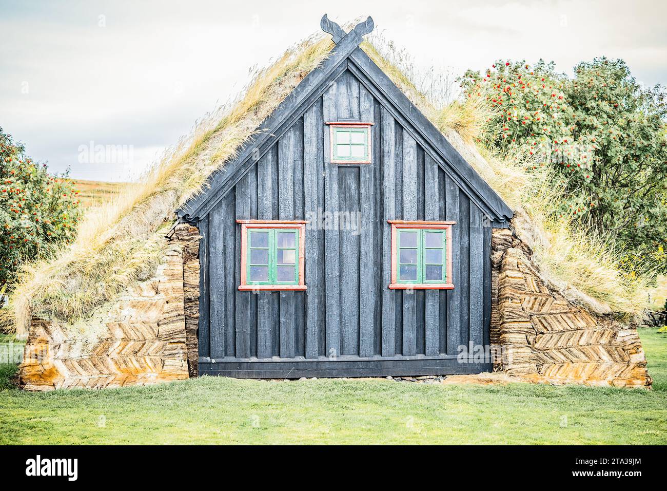A compact, two-story building with an exterior covered in lush green ...