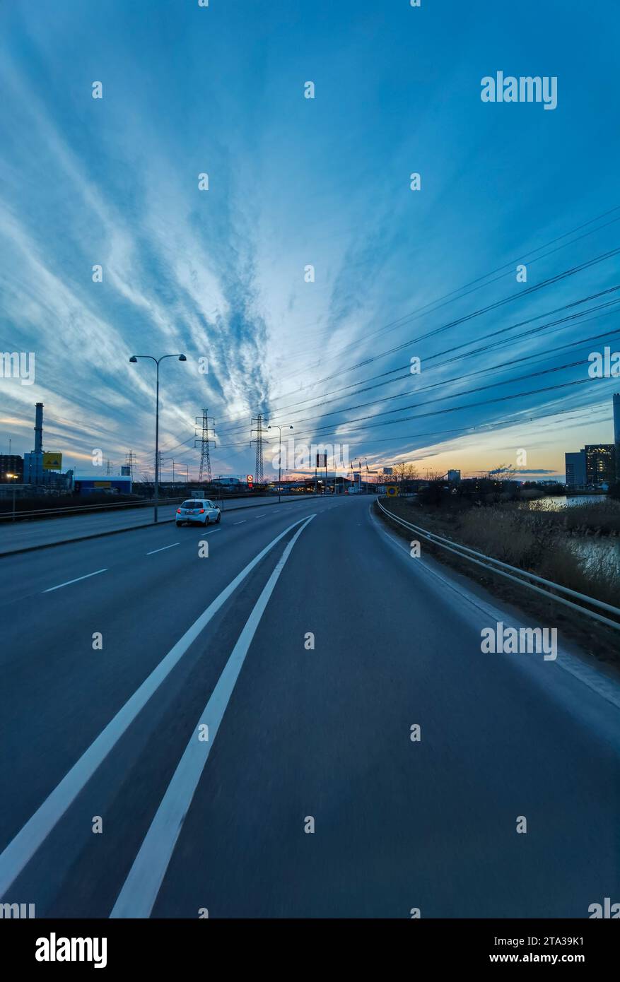 A scenic highway with multiple lanes of traffic, stretching into the ...