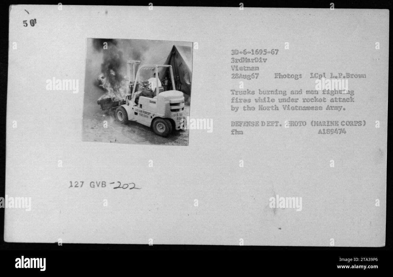 Trucks burn and soldiers battle fires during a rocket attack in Vietnam ...