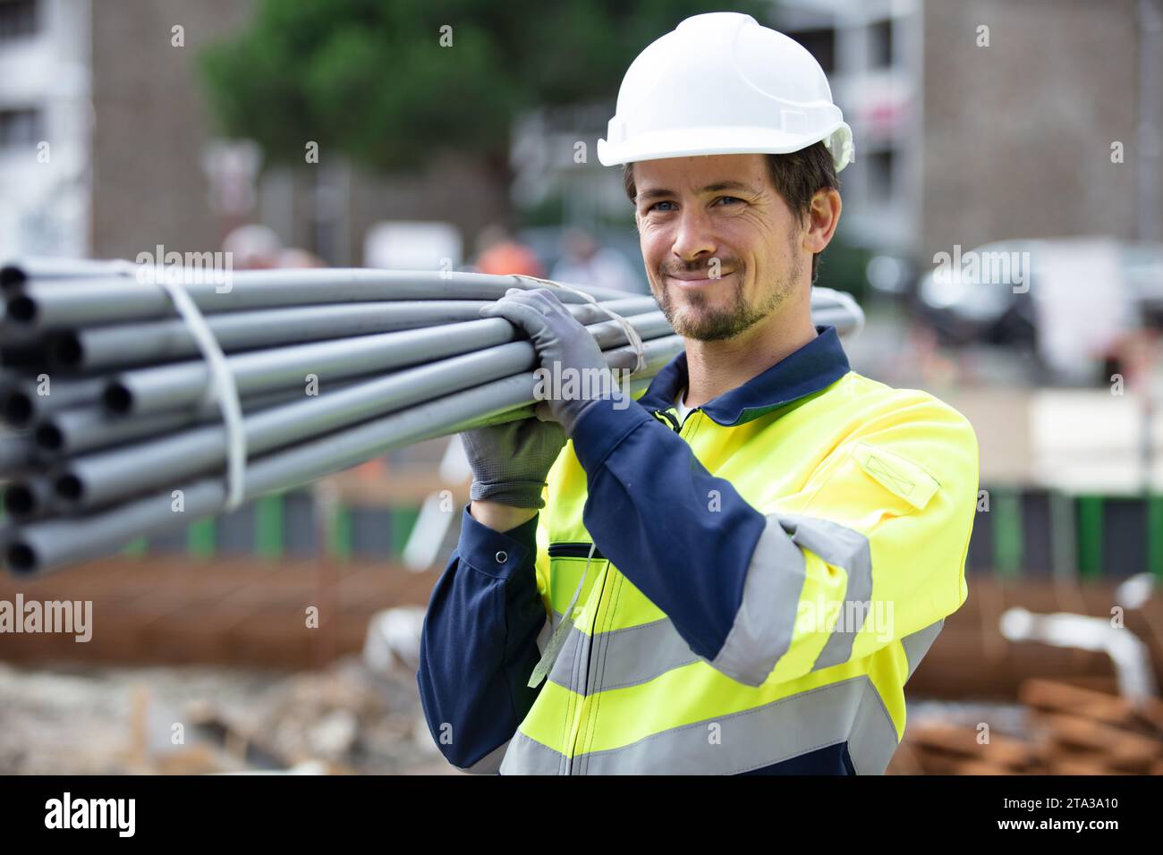 Construction worker carrying pipes hi-res stock photography and images ...