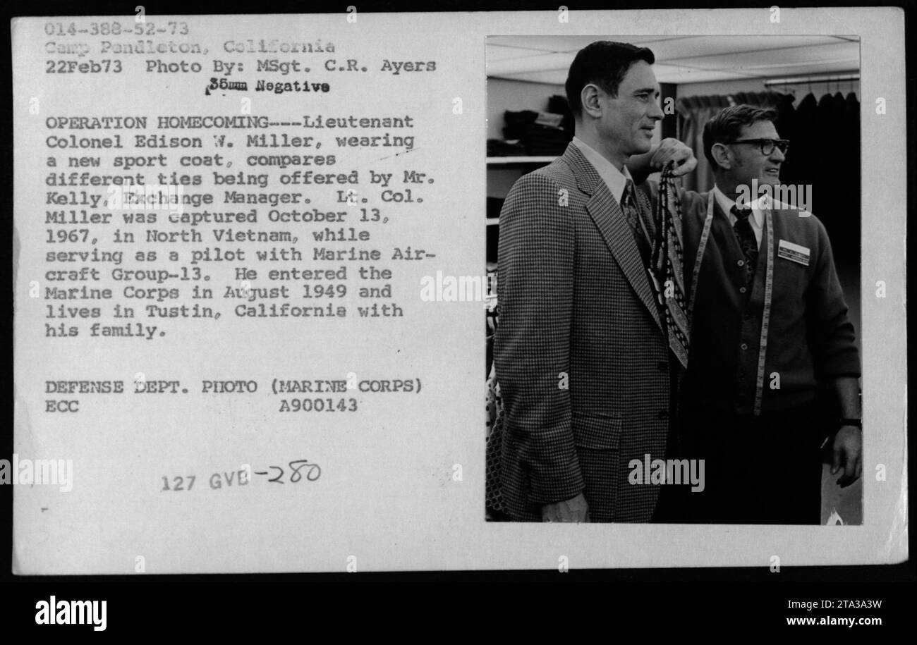 Lieutenant Colonel Edison W. Miller, a former POW, is seen comparing ...