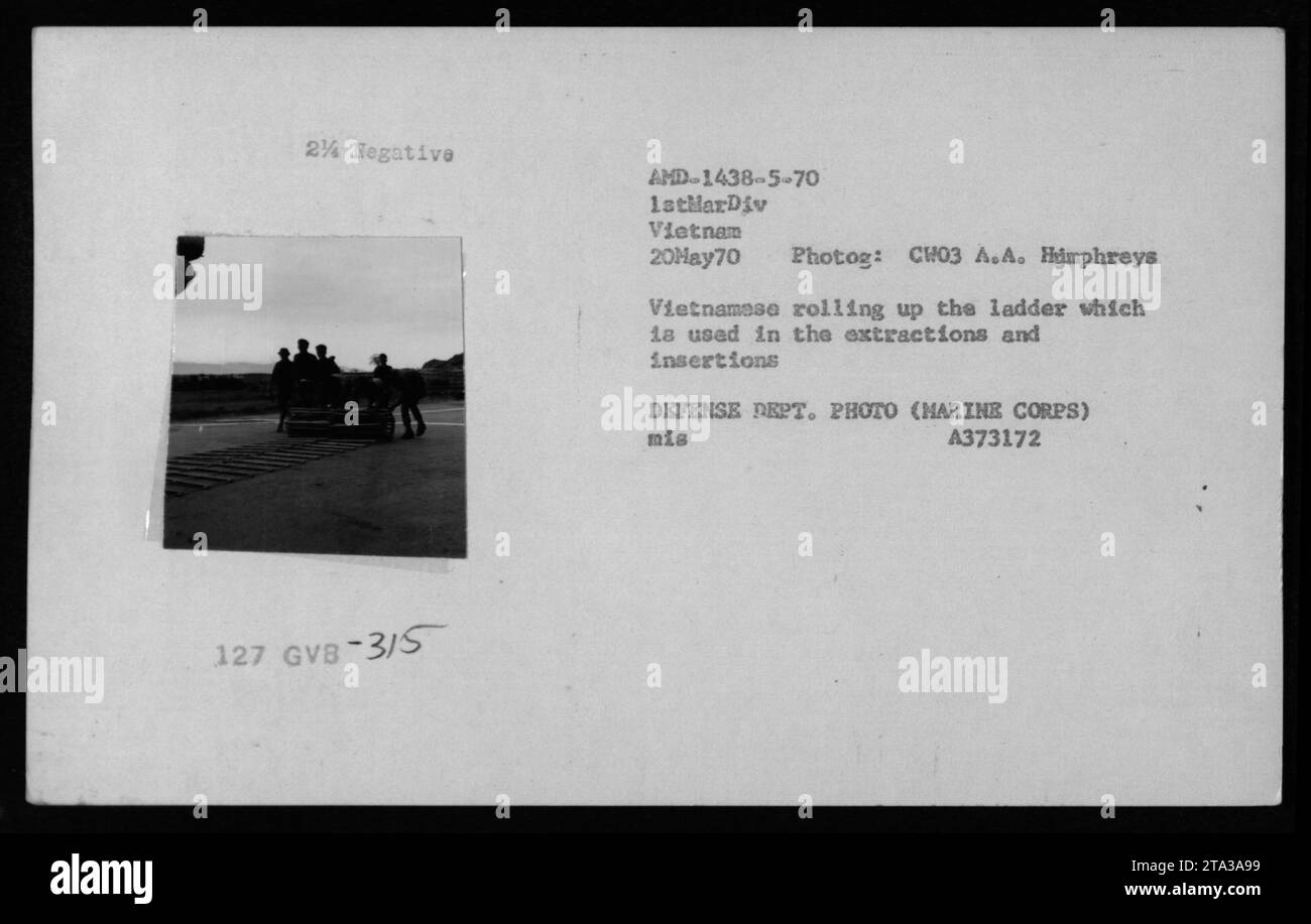 ARVN soldier rolling up a ladder used in extractions and insertions ...