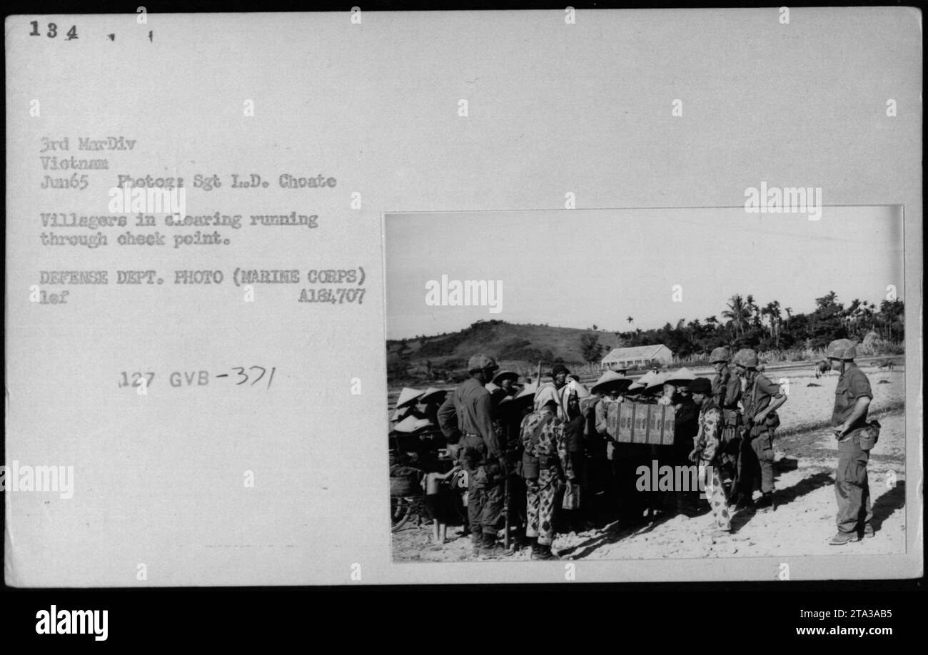 In June 1965, villagers were photographed running through a military ...