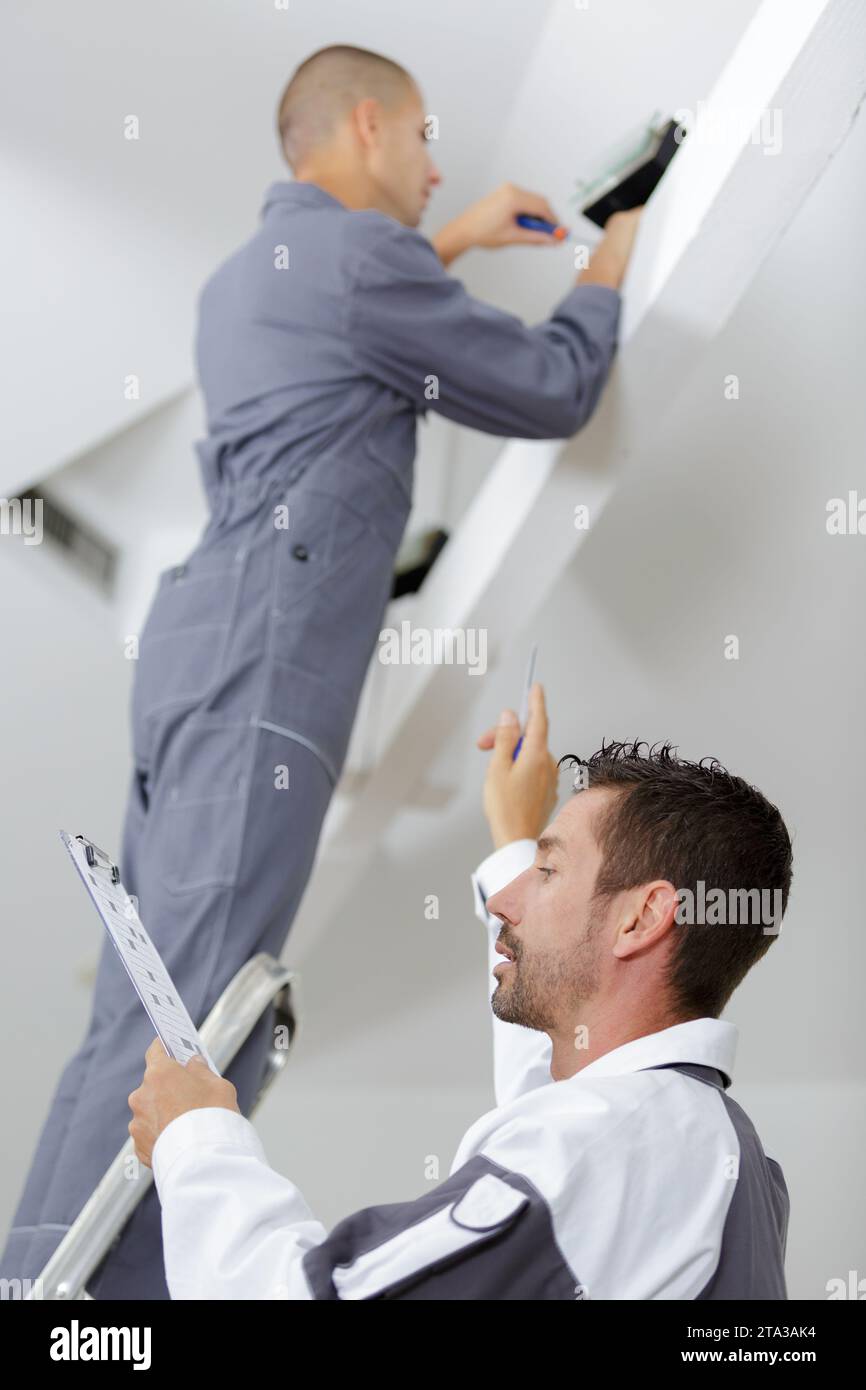 a painting apprentice and teacher Stock Photo - Alamy