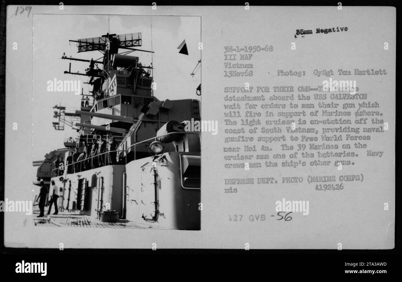 Marines aboard the USS GALVESTON preparing to fire their gun in support ...