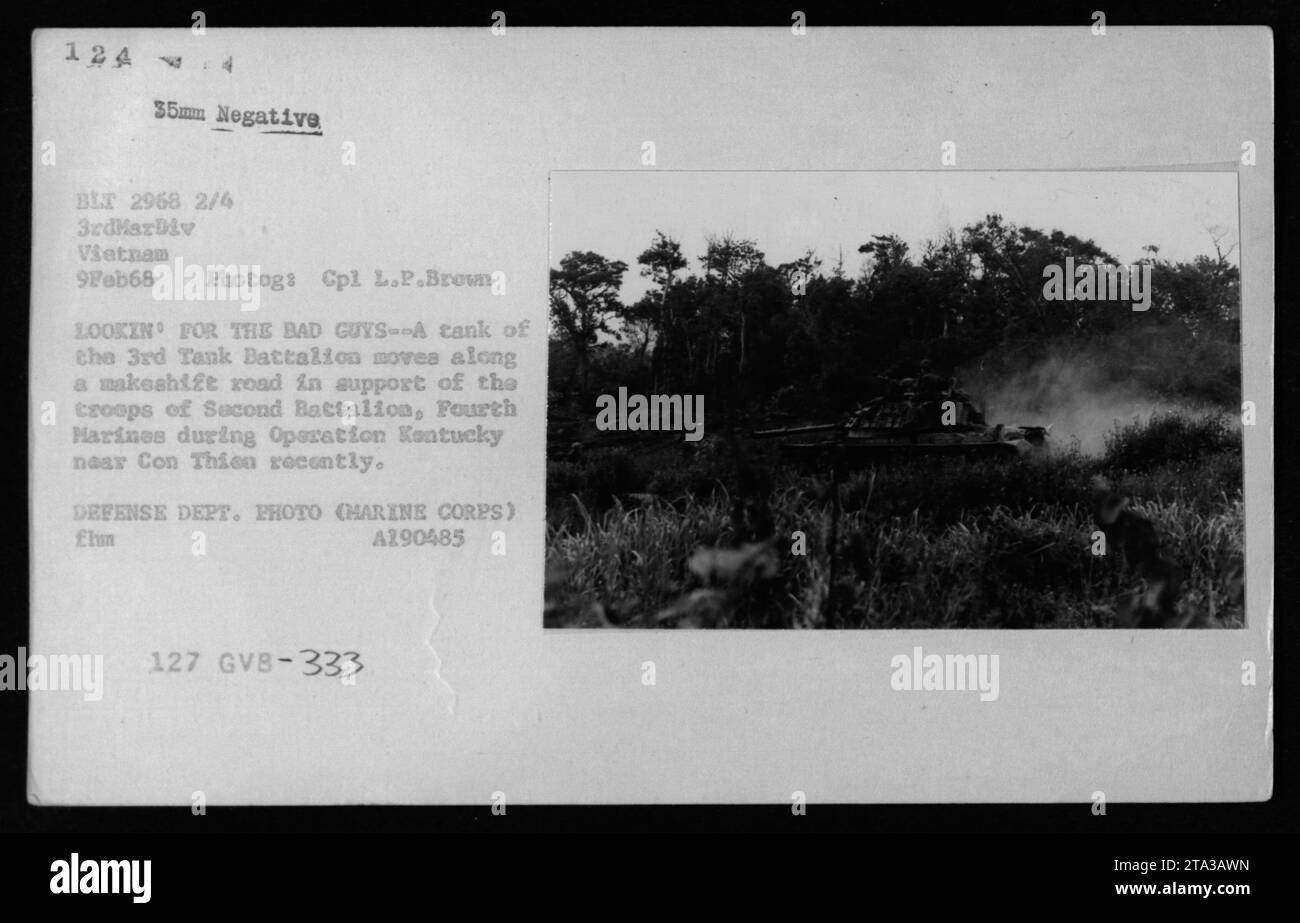 A tank of the 3rd Tank Battalion moves along a makeshift road in ...