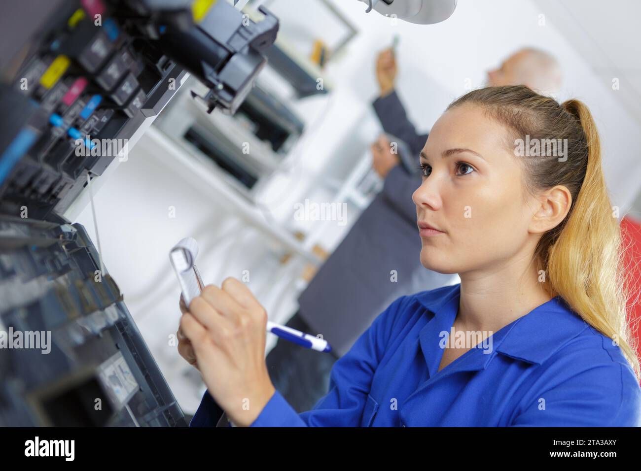 a woman fixing a printer Stock Photo - Alamy
