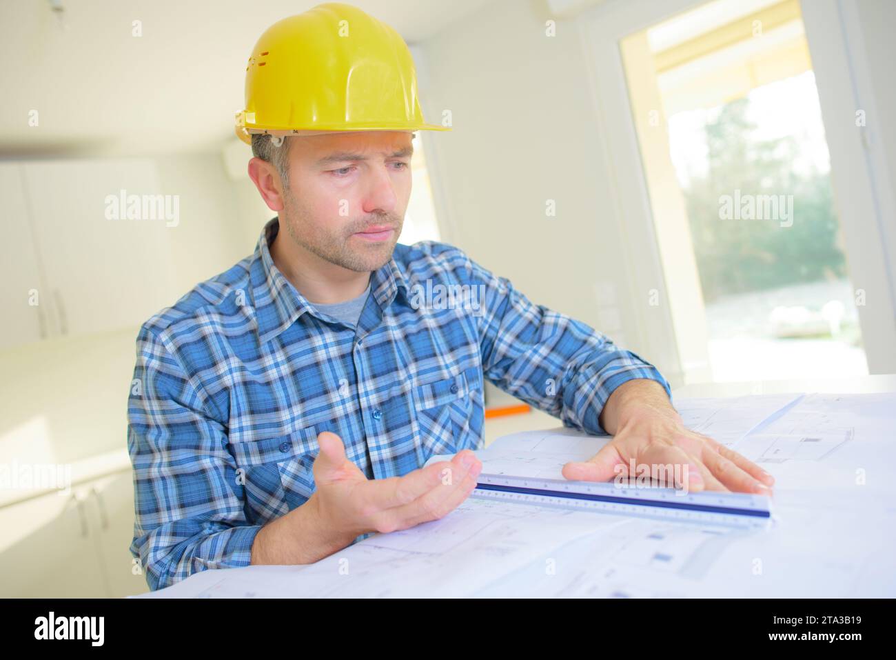 male architect using scale ruler puzzled expression Stock Photo - Alamy