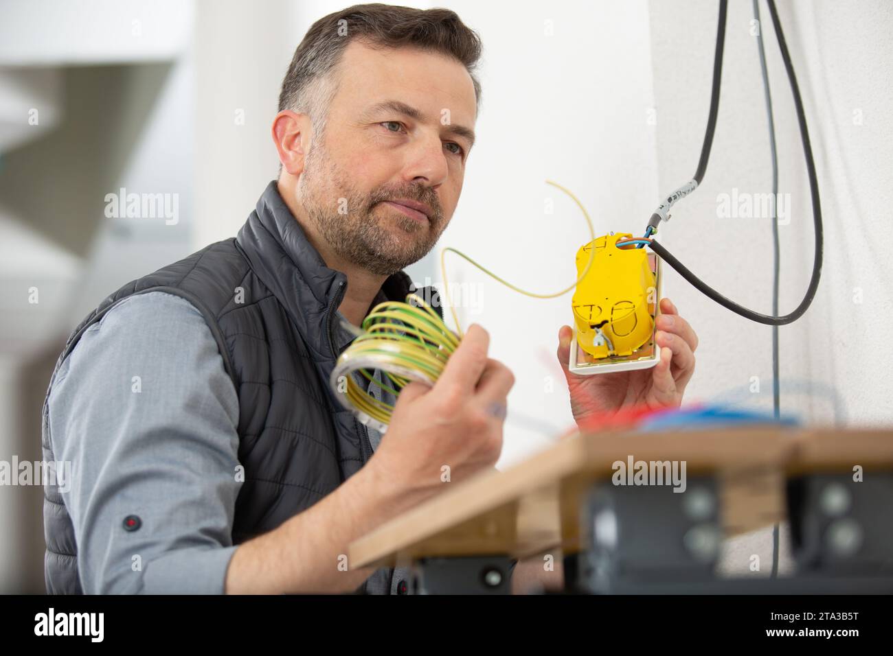man wiring up a junction box Stock Photo - Alamy