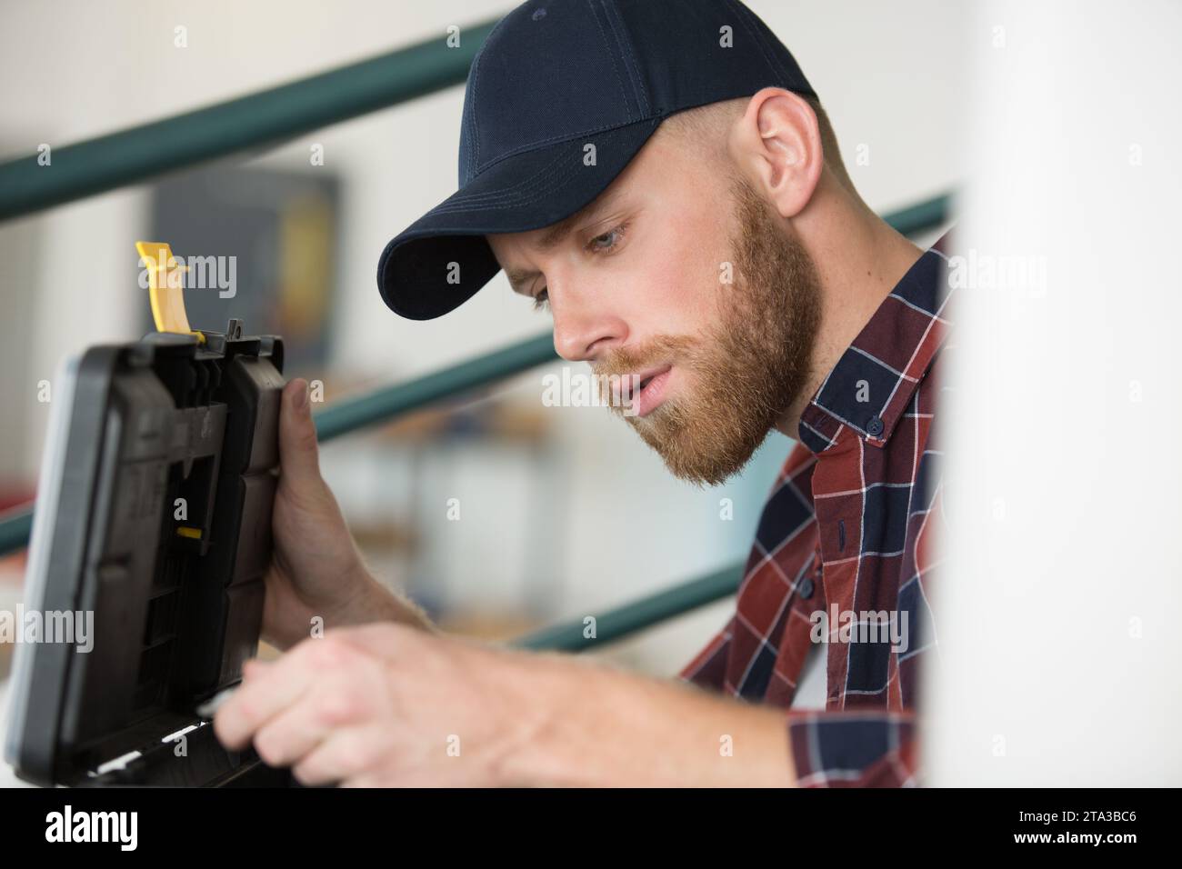 man looking in his tool box Stock Photo - Alamy