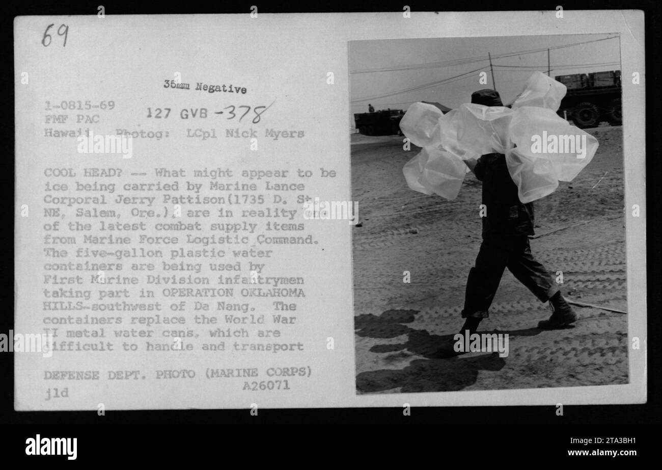 Lance Corporal Jerry Pattison carries five-gallon plastic water ...
