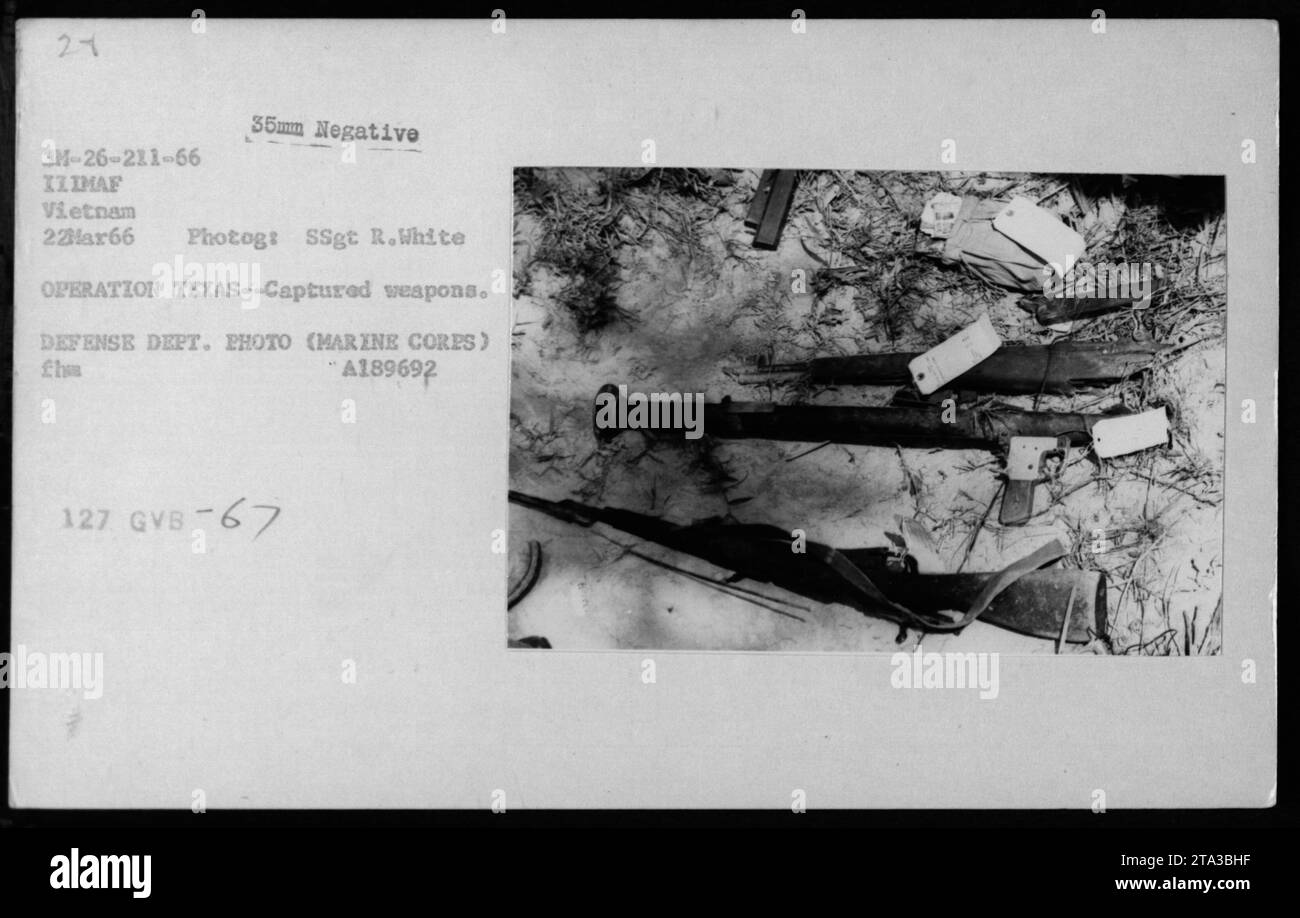 American forces display captured weapons, including firearms and ...