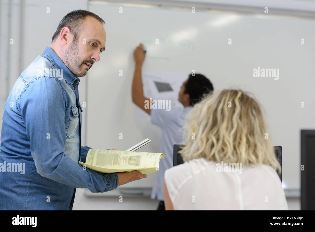 Girl books talking teacher hi-res stock photography and images - Alamy