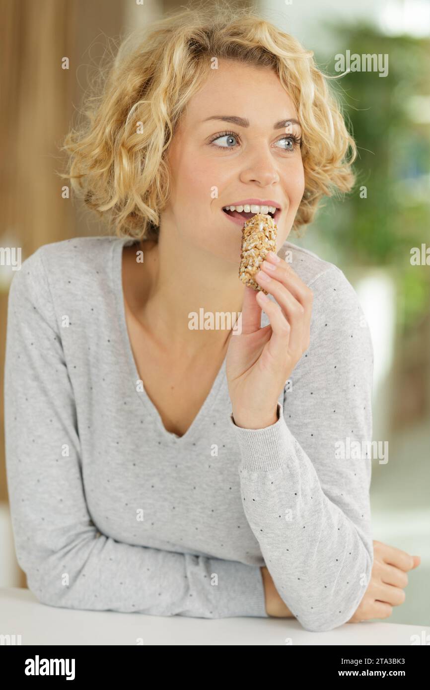 Woman eating protein bar hi-res stock photography and images - Alamy