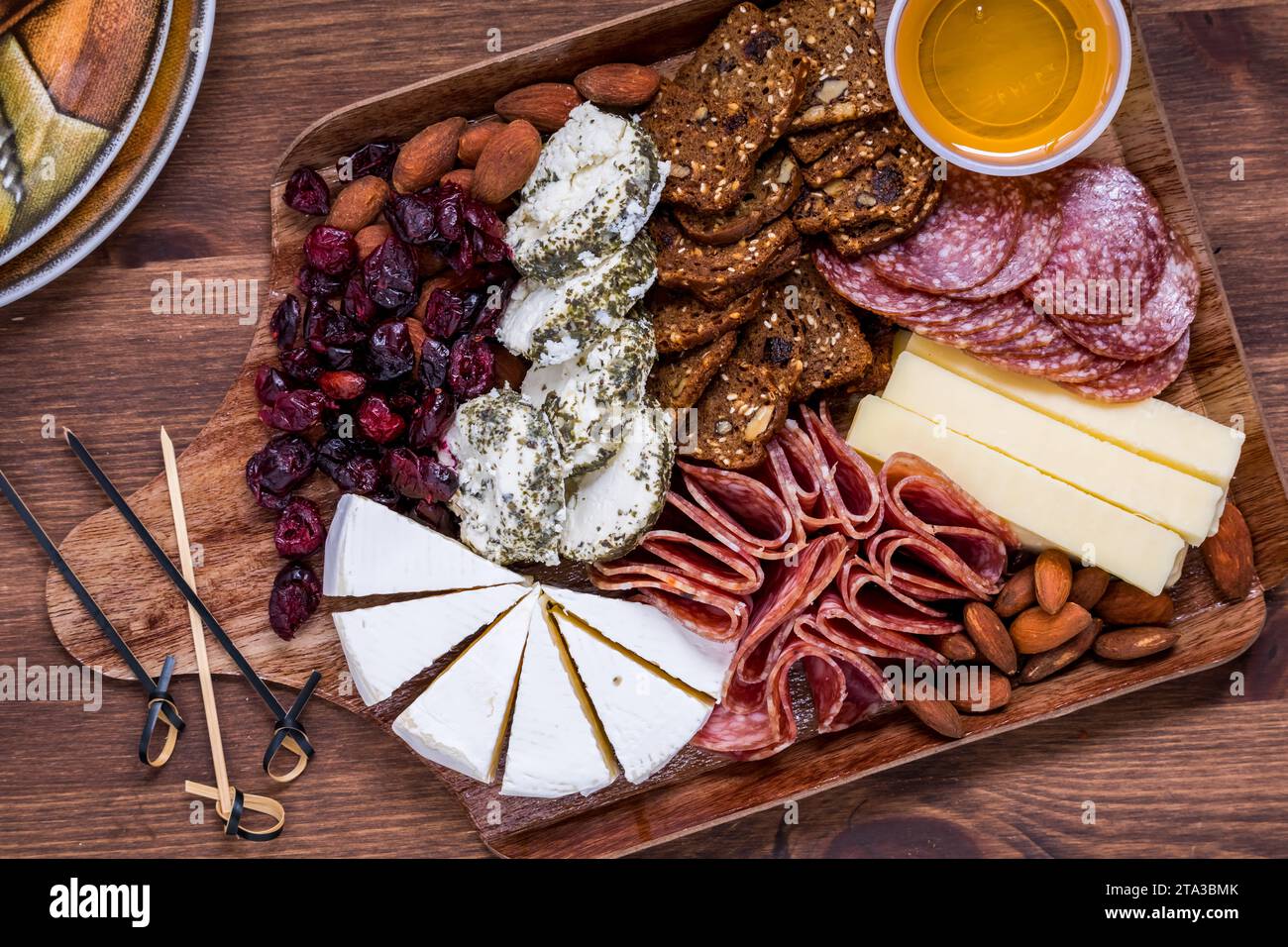 Top down view of a charcuterie board with various cheese, deli meat and ...
