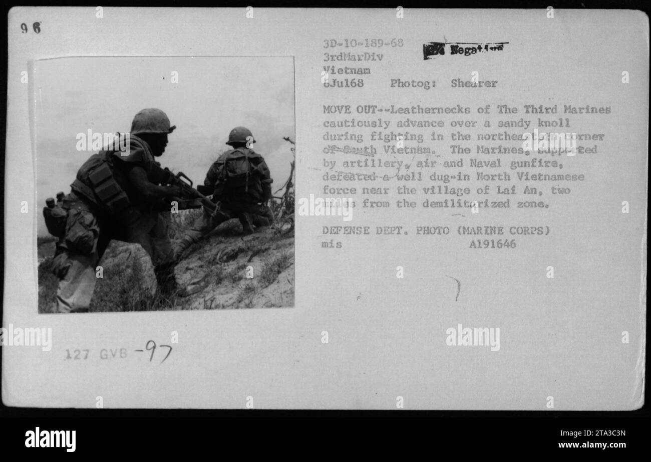 "Marines of the Third Division carefully progressing over a sand dune ...
