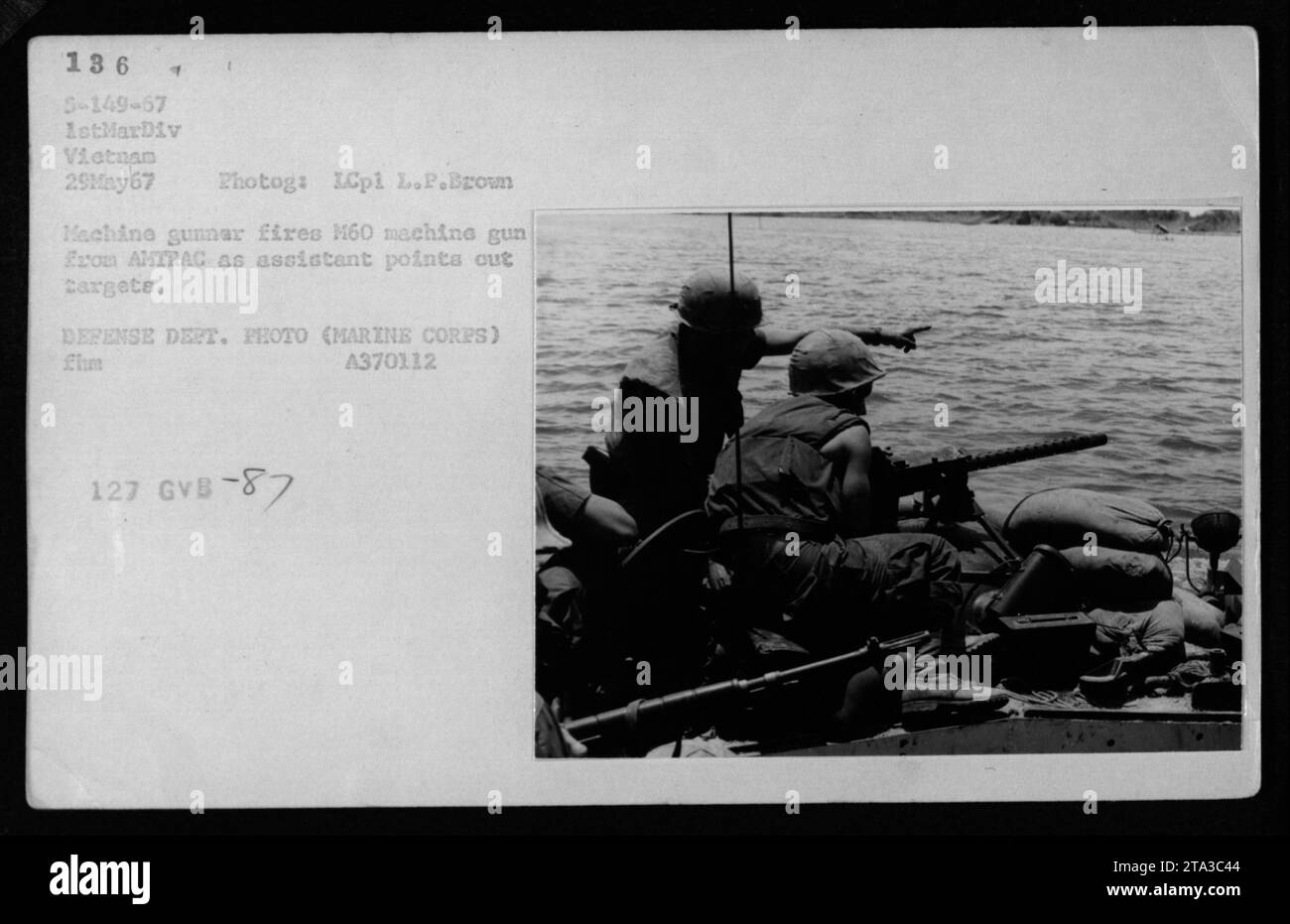 Marine Corps machine gunner fires an M60 machine gun from an AMTRAC ...