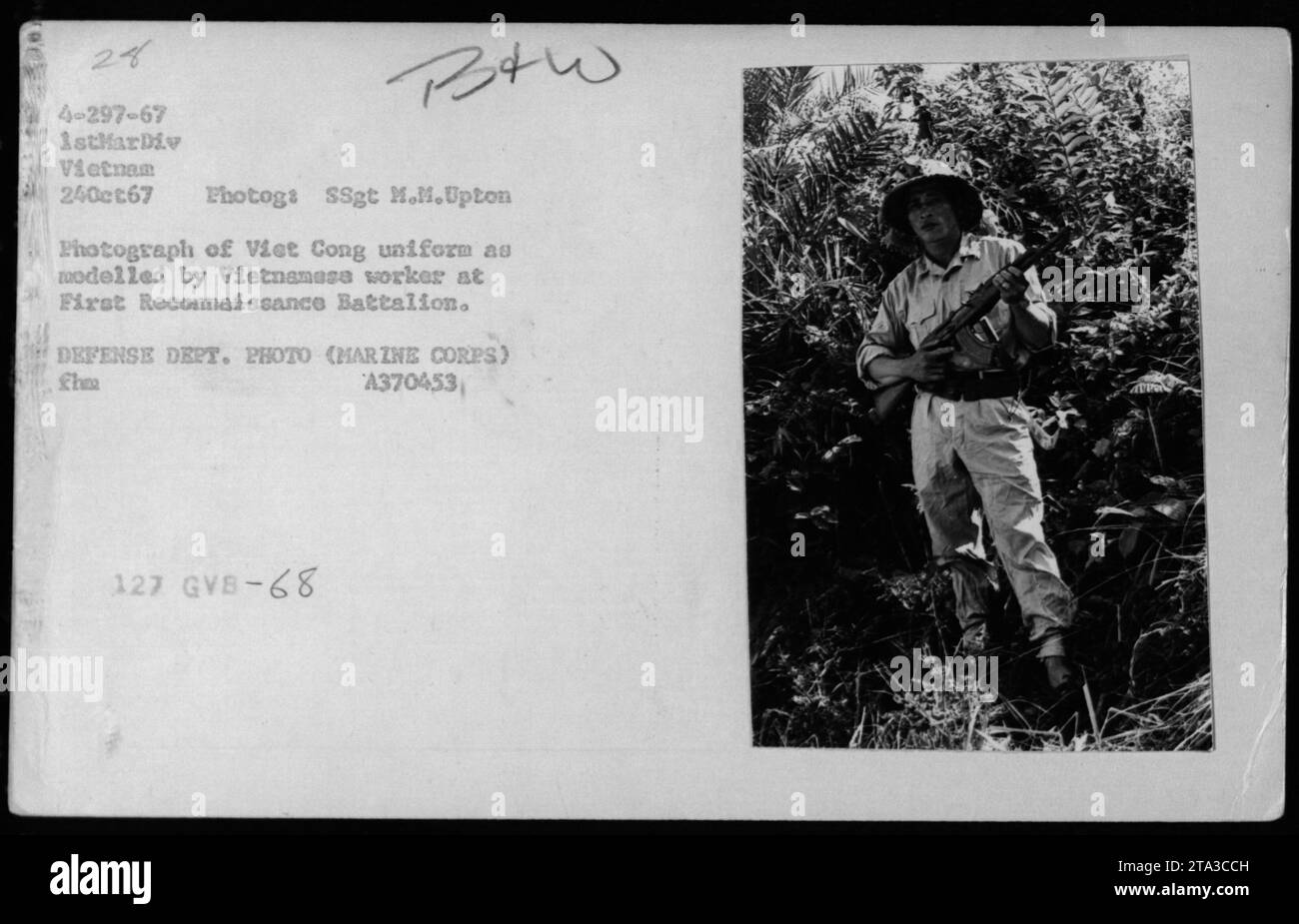A photograph depicting a Vietnamese worker modeling a Viet Cong uniform ...