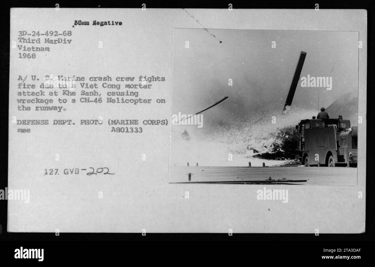 US Marine crash crew extinguishing fire caused by a Viet Cong mortar ...