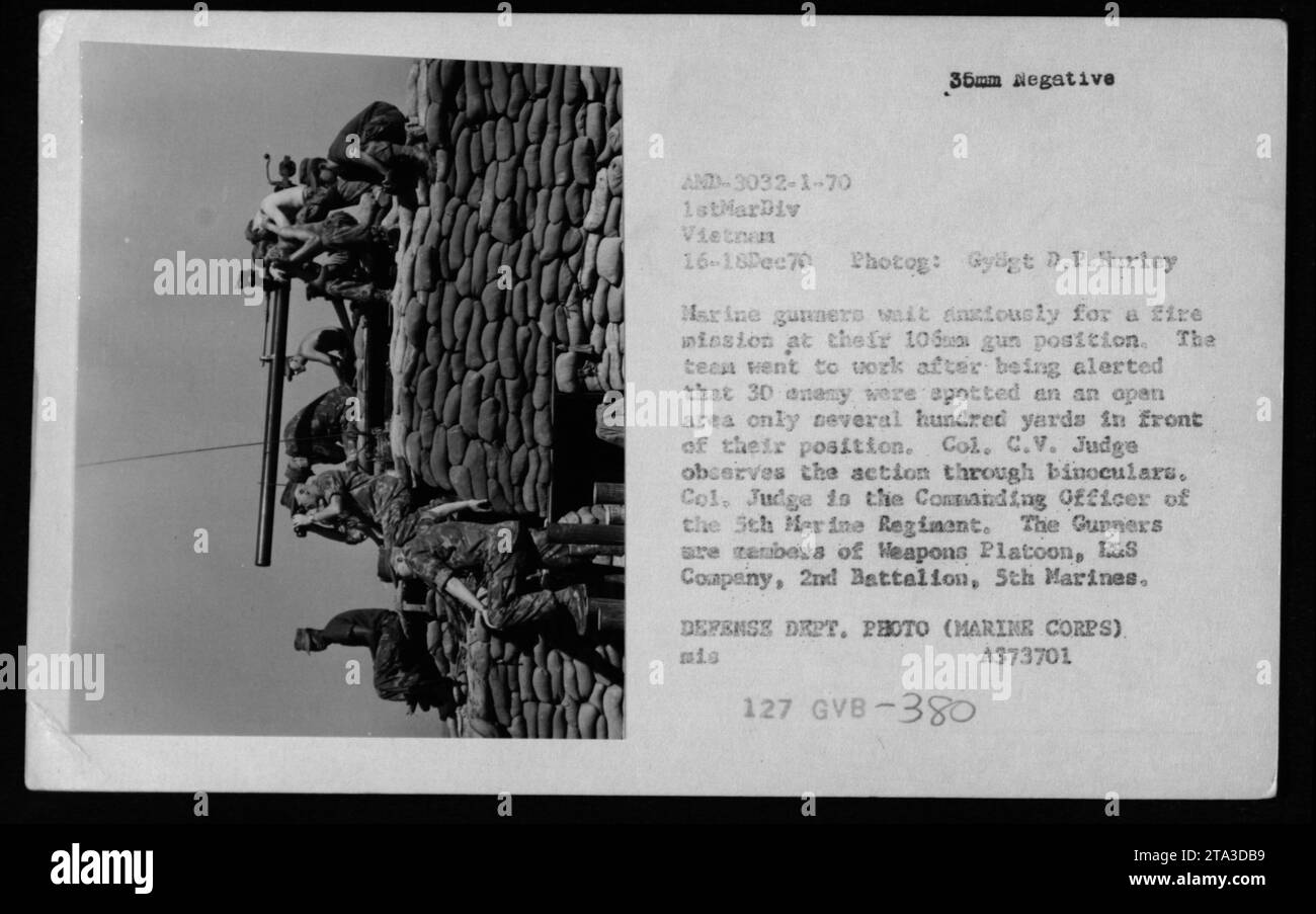 Marine gunners, part of the 1st Marine Division, await a tire mission ...