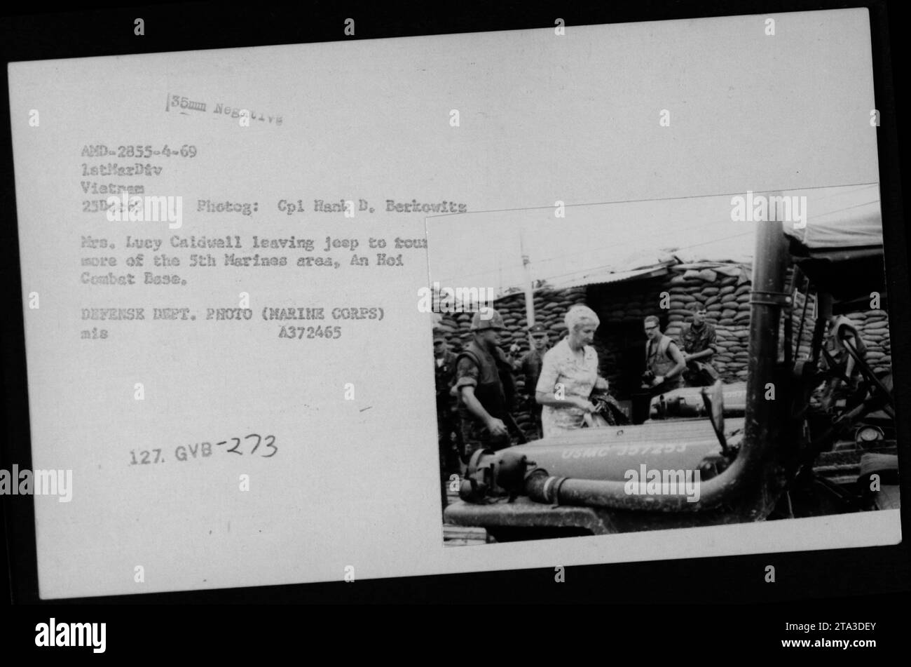 Mrs. Lucy Caldvall, accompanied by military officials, steps out of a ...