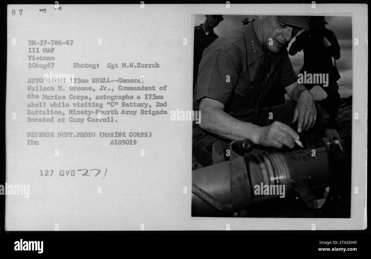 Commandant of the Marine Corps, General Wallace M. Greane, autographs a ...