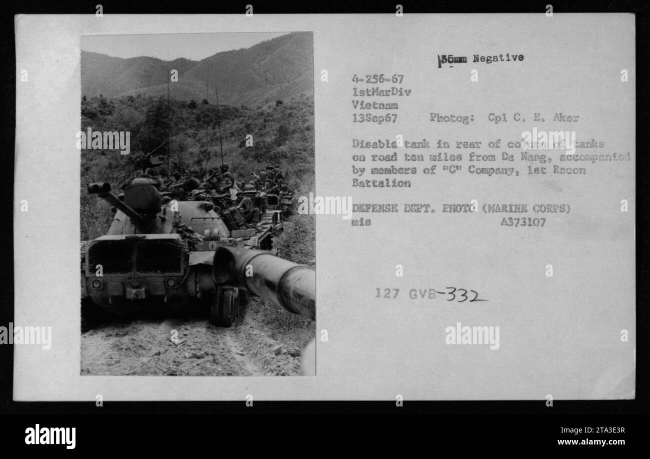 A disabled tank is seen at the rear of a column of tanks on a road, ten ...