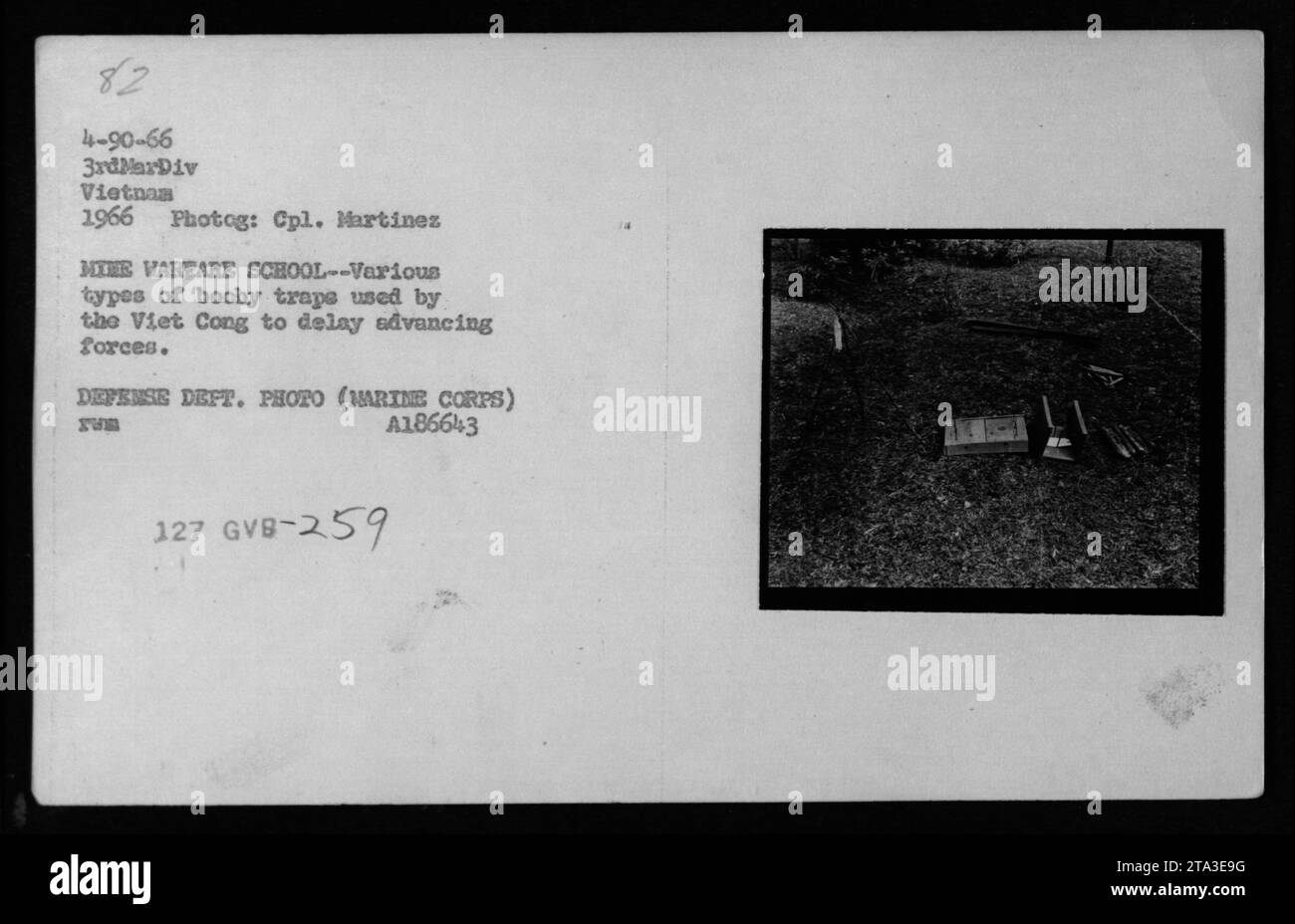 A soldier inspects various types of booby traps used by the Viet Cong ...