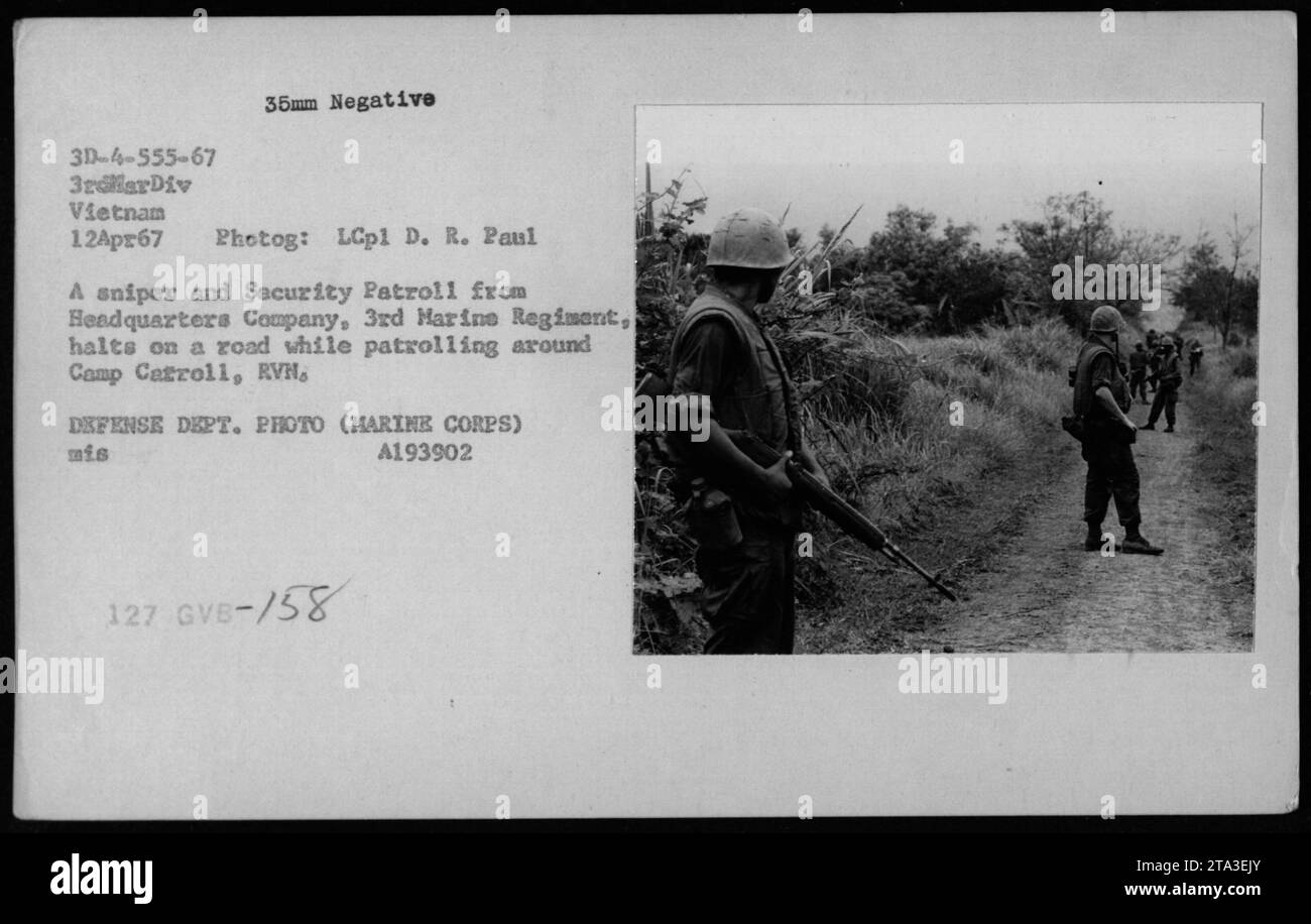 A soldier from the 3rd Marine Regiment pauses on a road near Camp ...