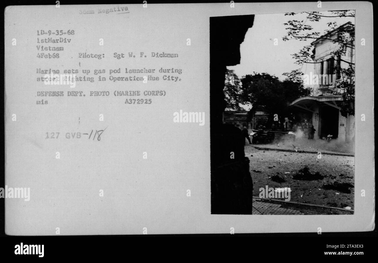 Marine Corps Sgt W. F. Dickman setting up a gas pod launcher during ...