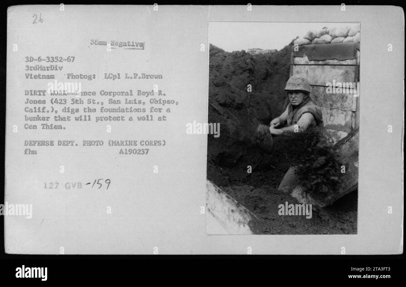 Lance Corporal Boyd R. Jones digs foundations for a bunker protecting a ...