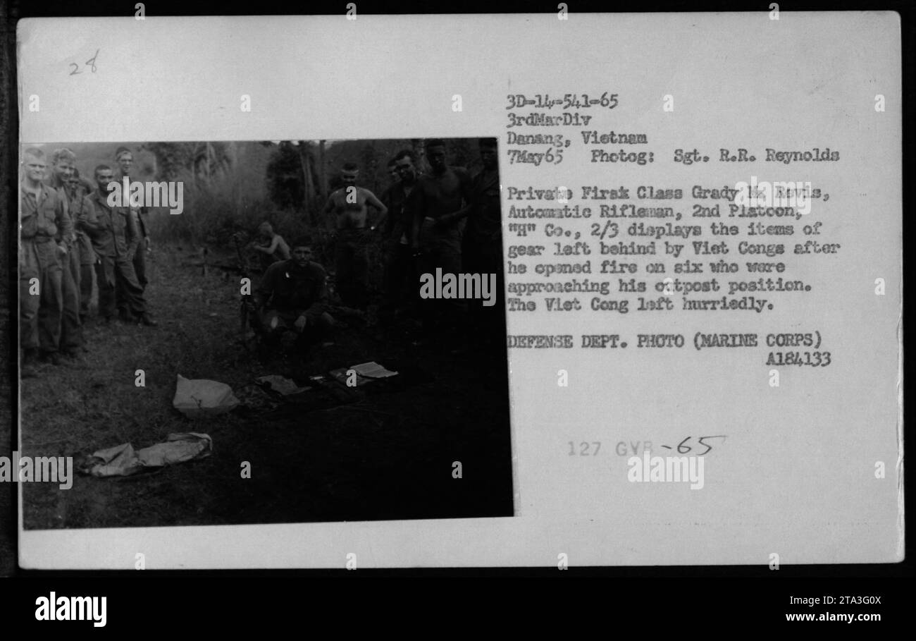Pvt. Grady M. Rovis, Automatic Rifleman, 2nd Platoon, displays captured ...