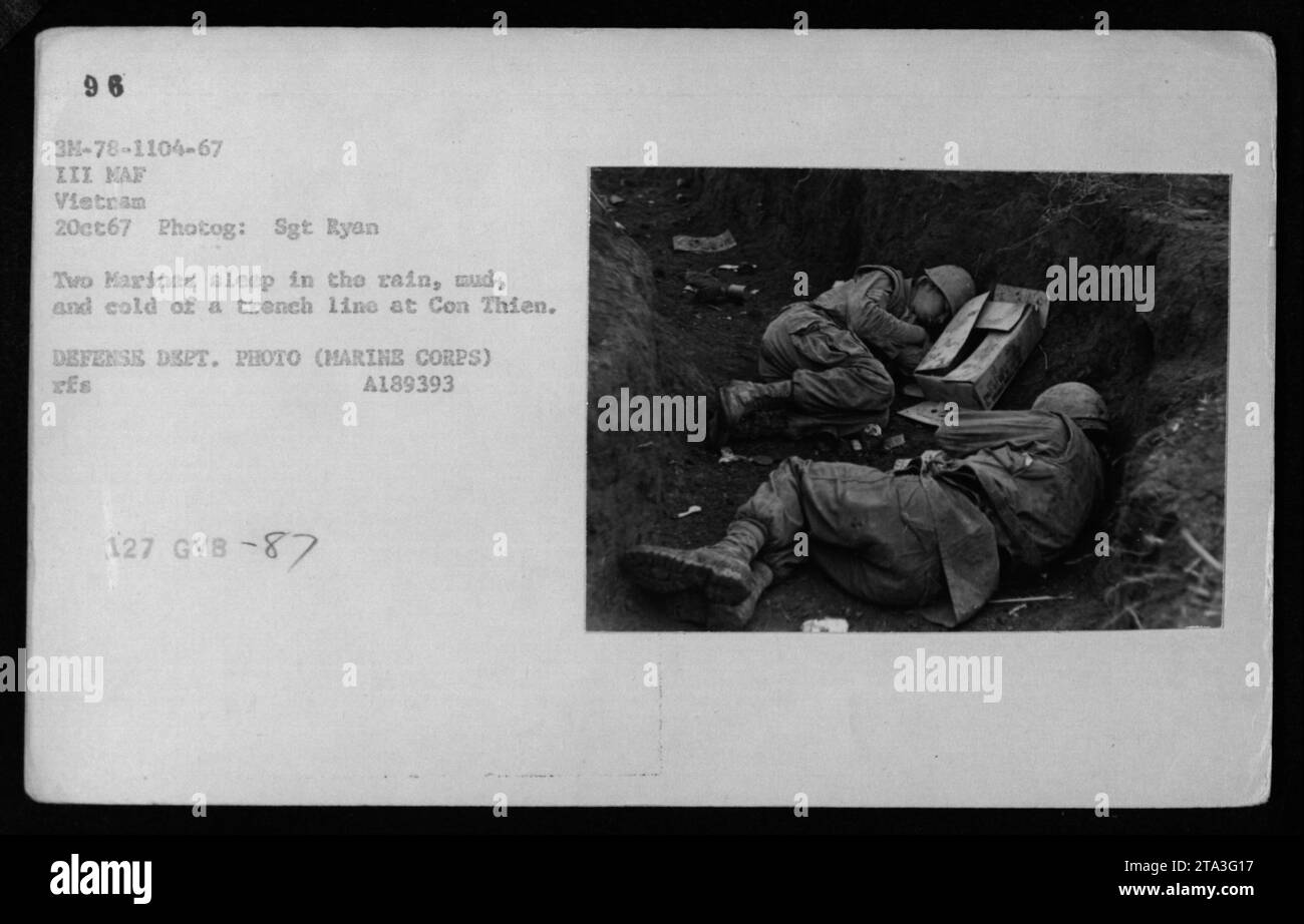 Marines take shelter in a muddy trench at Con Thien on October 2, 1967 ...