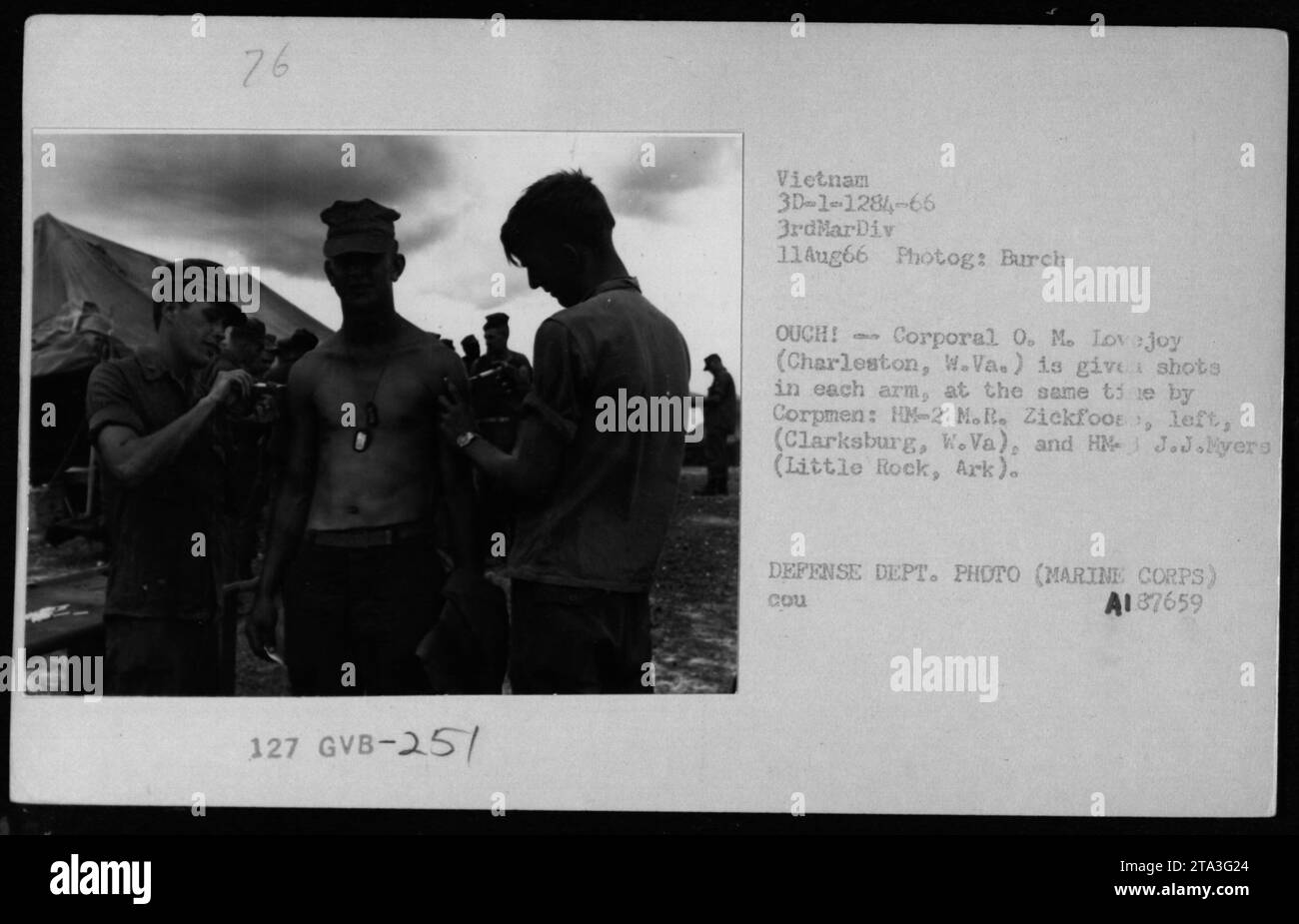 Corporal O.M. Lovejoy receives simultaneous injections from Corpsmen HM ...