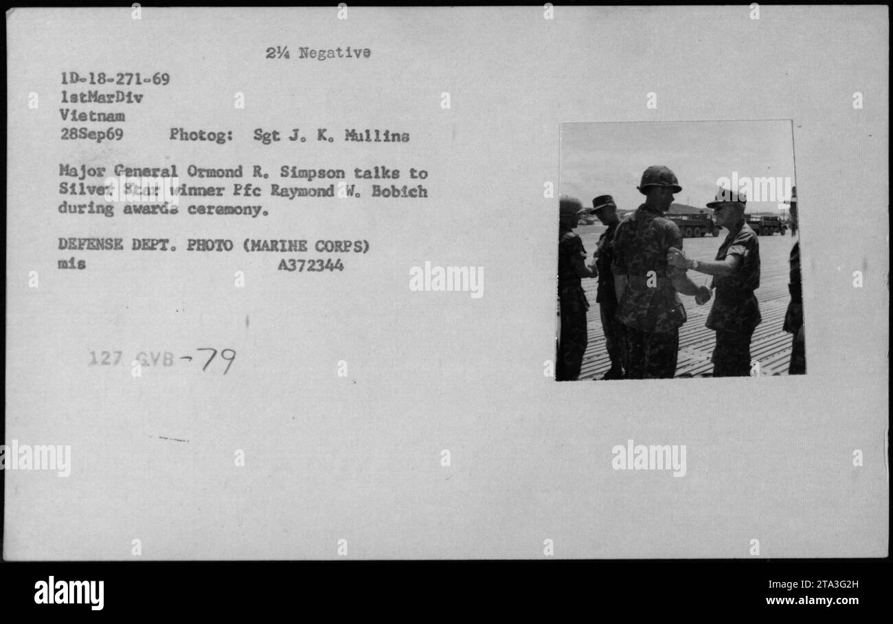 Major General Ormond R. Simpson engages in conversation with Pfc ...