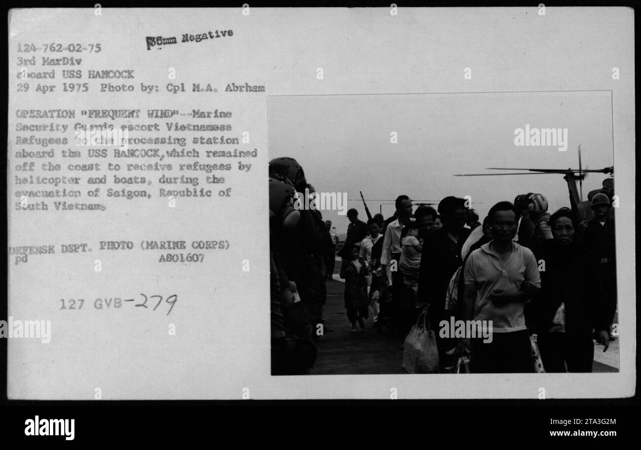 Marine Security Guards guide Vietnamese refugees to a processing ...