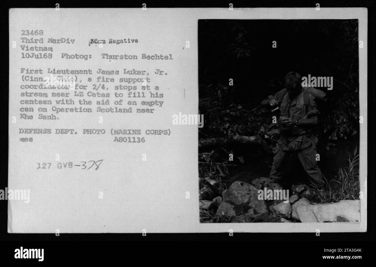 First Lieutenant James Luker Jr. fills his canteen from a stream near ...