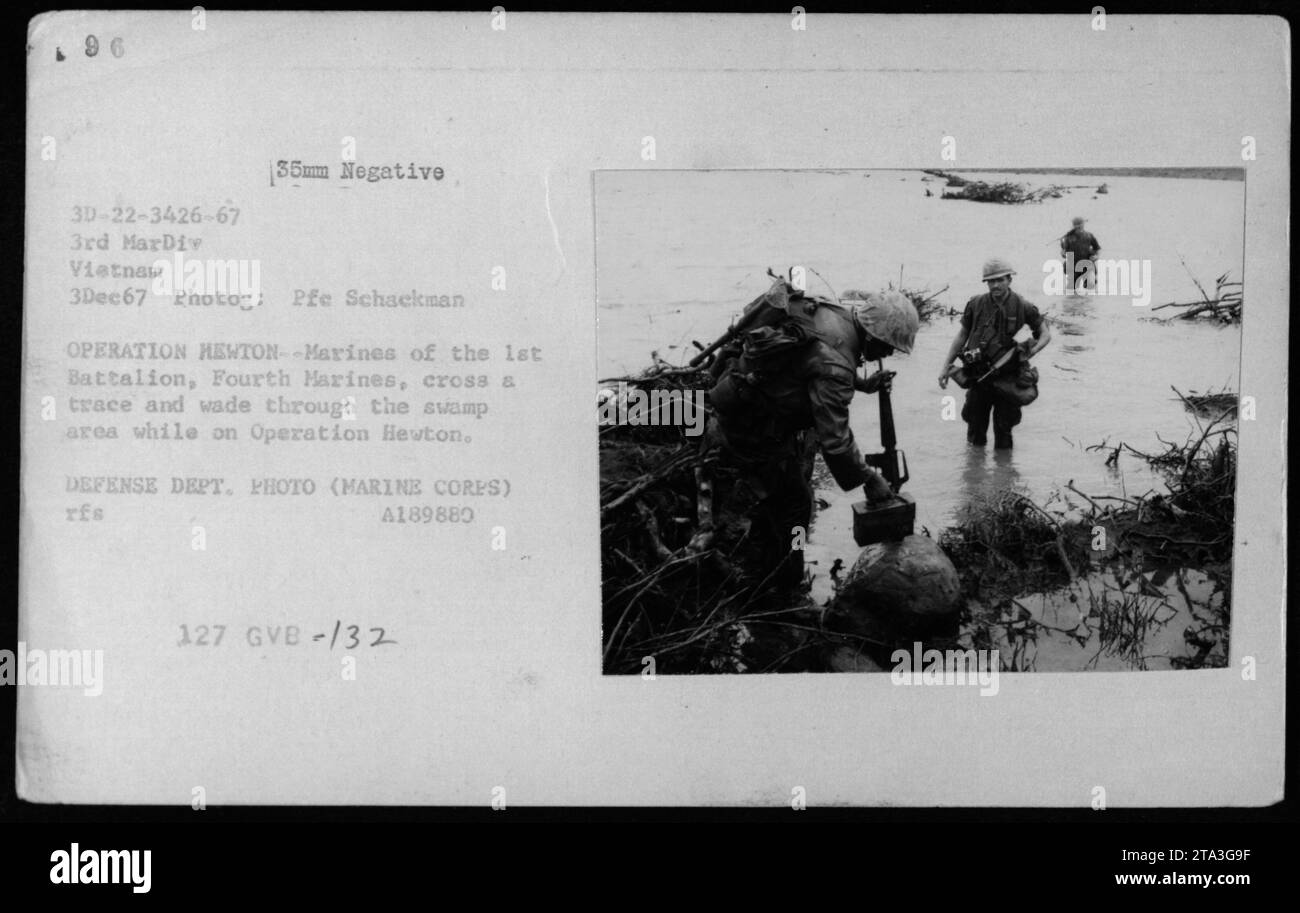 American troops of 1st Battalion, Fourth Marines wade through a swamp ...