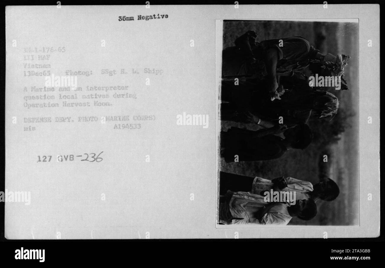 On December 13, 1965, Marines and an interpreter question local ...