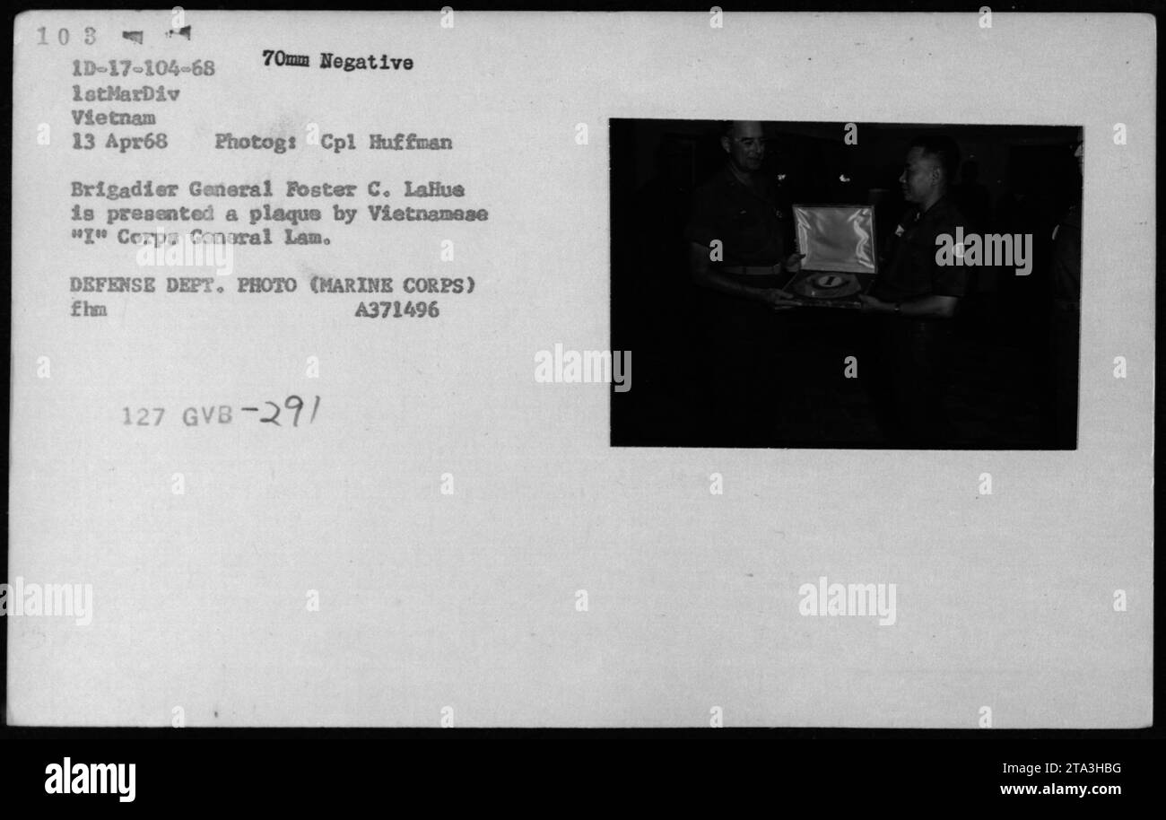 Brigadier General Foster C. Laflue receives a commemorative plaque from ...