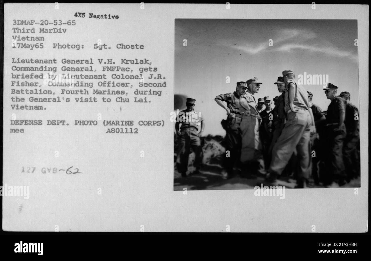 Lieutenant General V.H. Krulak, Commanding General, FMFPac, receives a ...