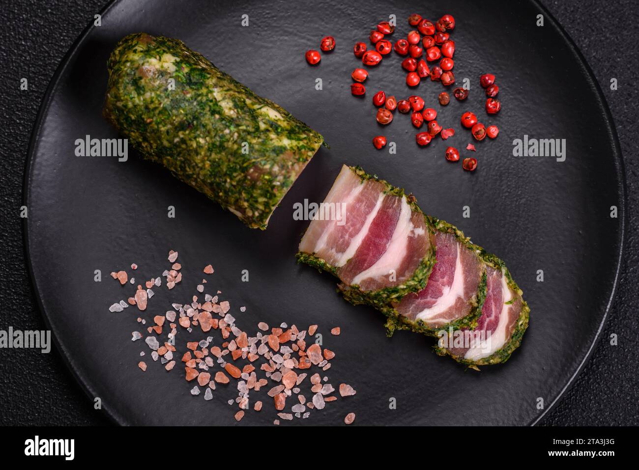 Delicious fresh bacon stripes with spices and salt on a dark concrete ...