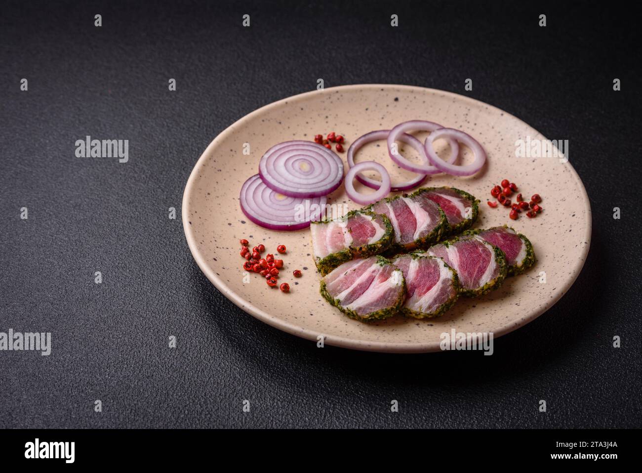 Delicious fresh bacon stripes with spices and salt on a dark concrete ...