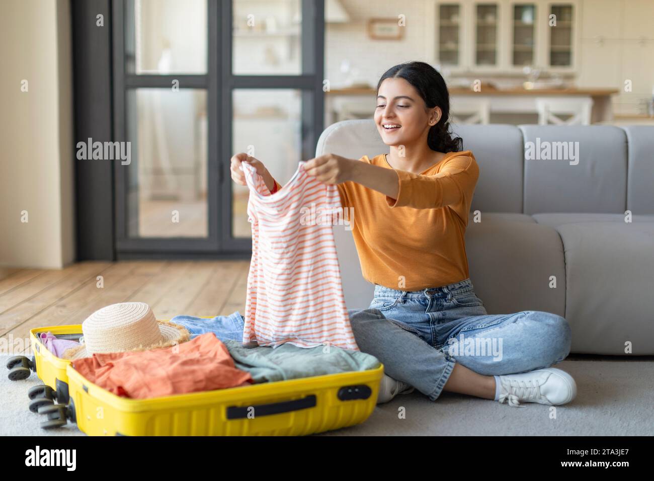 Travel Preparation. Young indian woman packing suitcase at home Stock ...