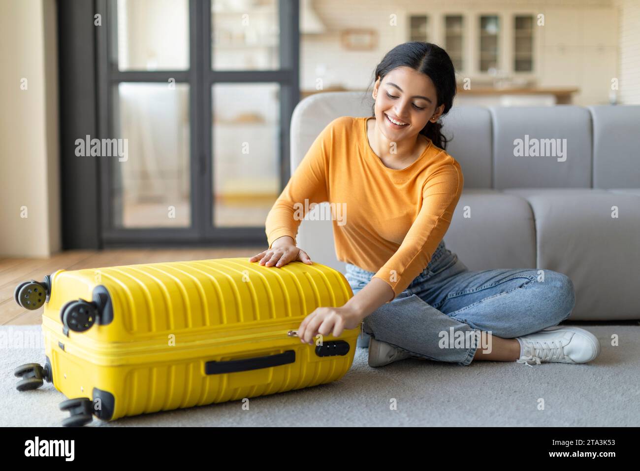 Smiling Indian Woman Packing Luggage At Home For Vacation Trip Stock ...