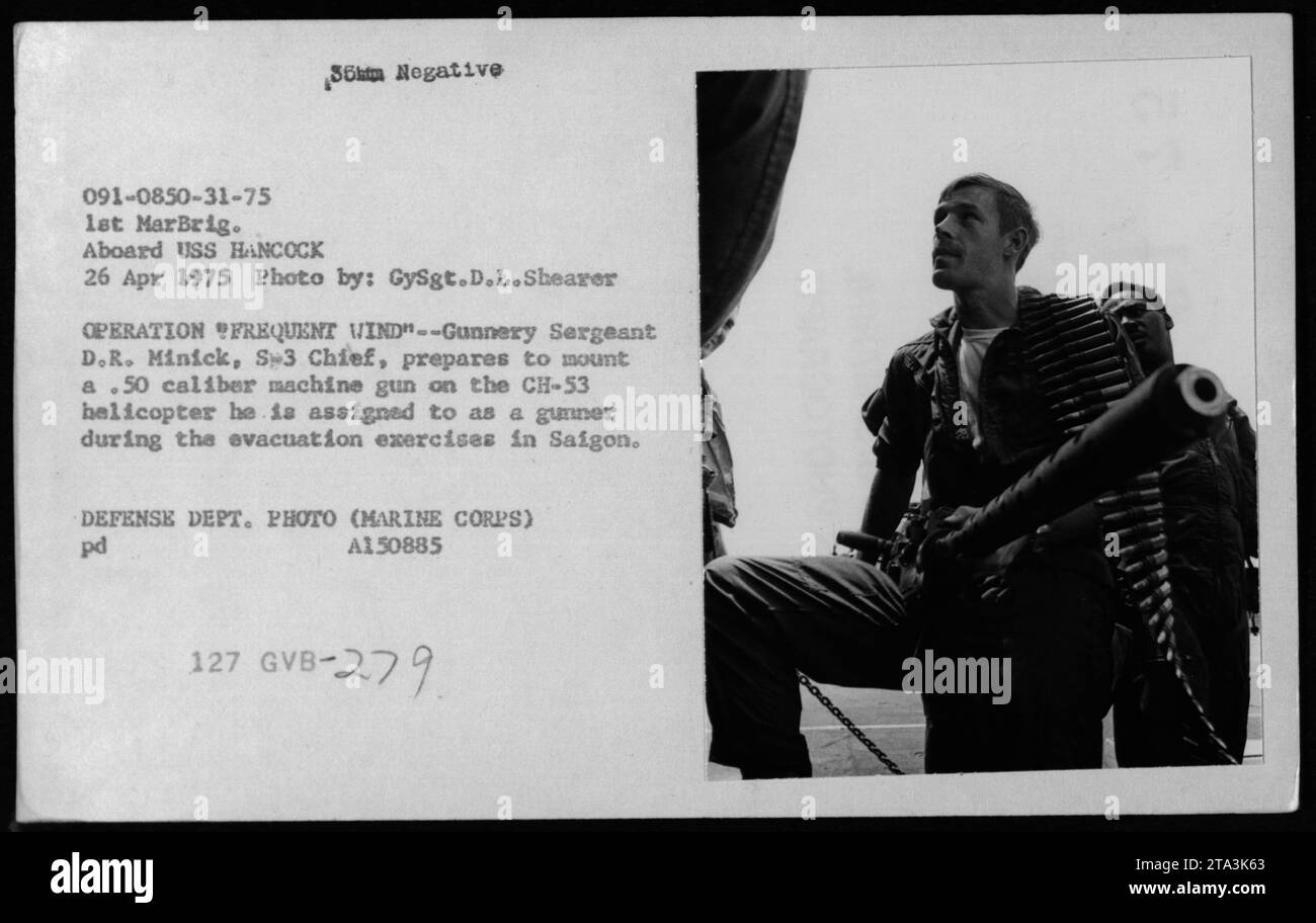 Gunnery Sergeant D.R. Minick, S3 Chief, prepares a .50 caliber machine ...